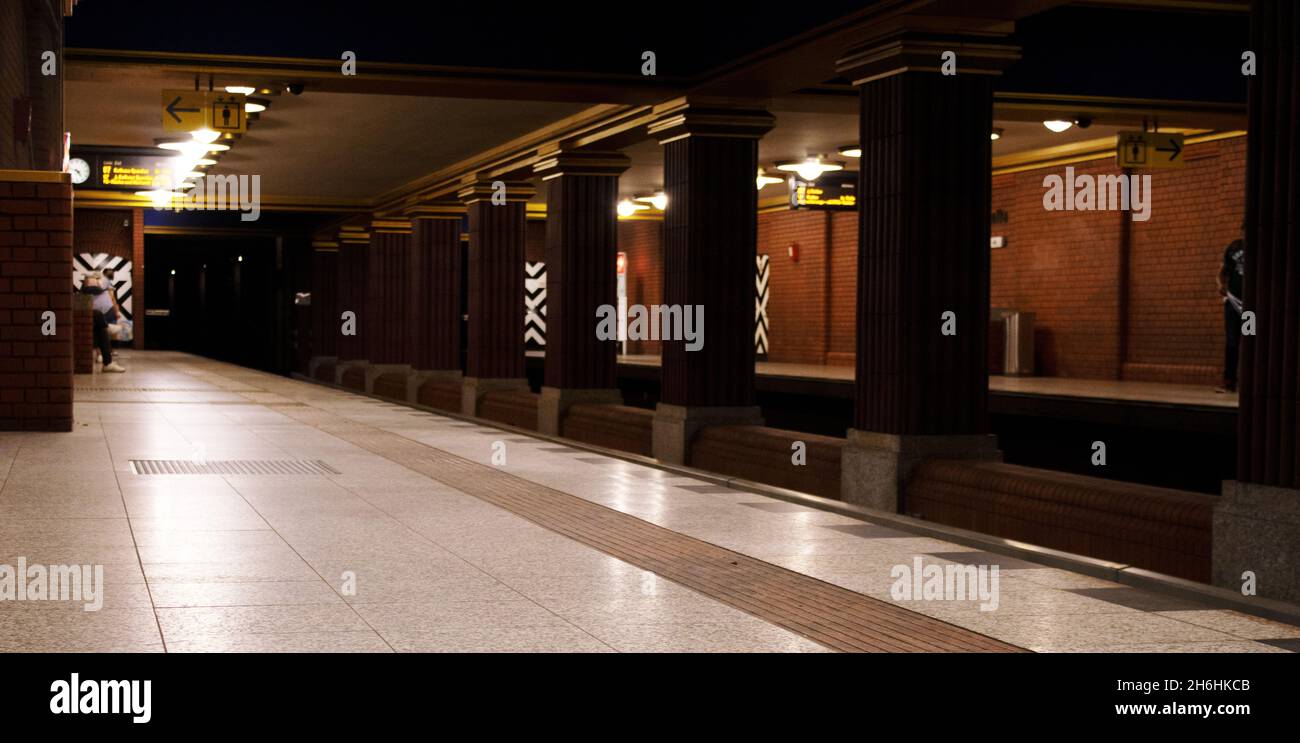 Inside of a station with lights at night Stock Photo - Alamy
