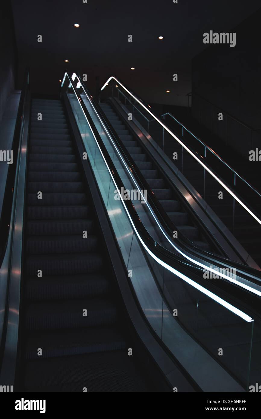 Vertical shot of escalators in a station at night Stock Photo - Alamy