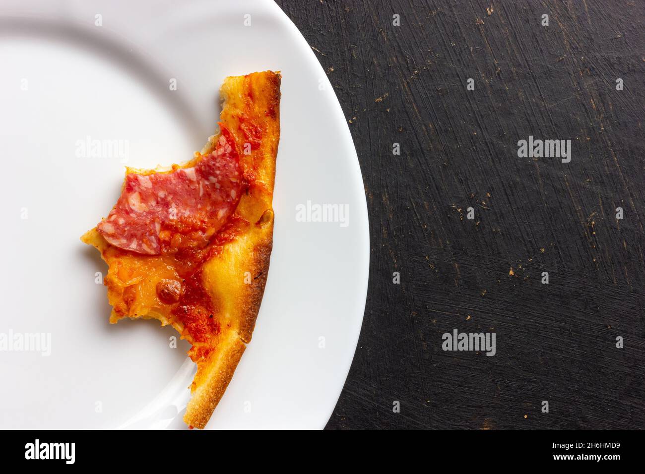 Half-eaten pizza. Dirty plate. Leftovers. Bitten pizza Stock Photo - Alamy