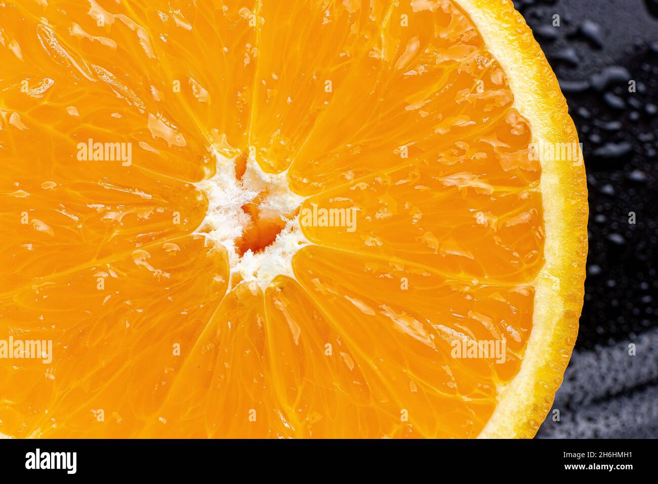 Orange slice. Half an orange. Cross section. Orange on a black ...