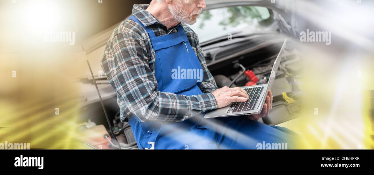 Car mechanic using laptop for checking car engine; multiple exposure ...