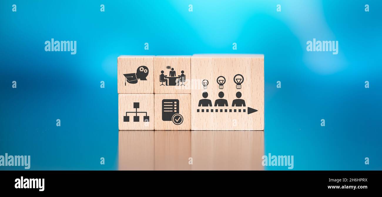 Wooden blocks with symbol of continuing education concept on blue ...