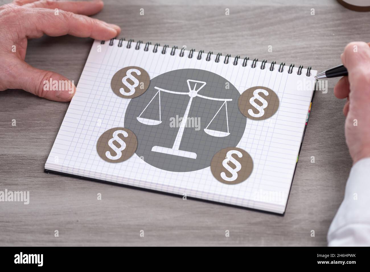 Hand holding a notepad with law concept Stock Photo - Alamy