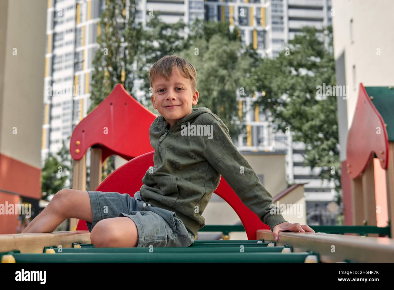 Kids play on the playground. Happy laughing boy and girl have fun ...