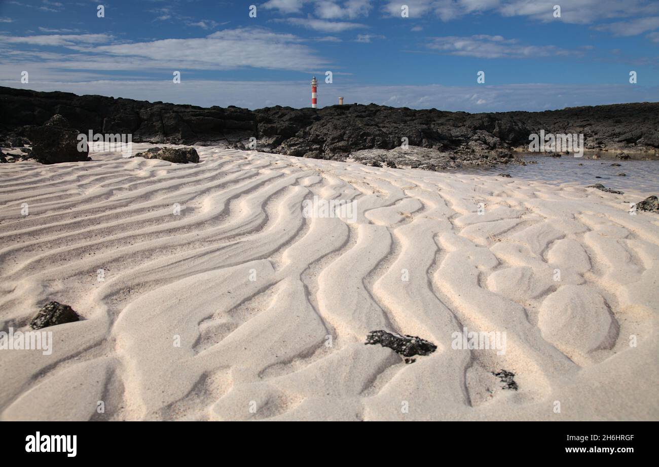 natural sand pattern created by a flow of tide and ripples on the edge ...
