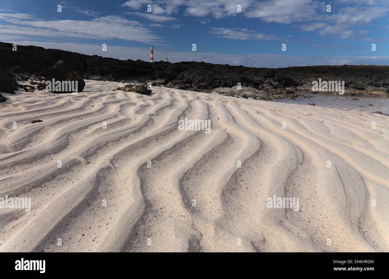 natural sand pattern created by a flow of tide and ripples on the edge ...