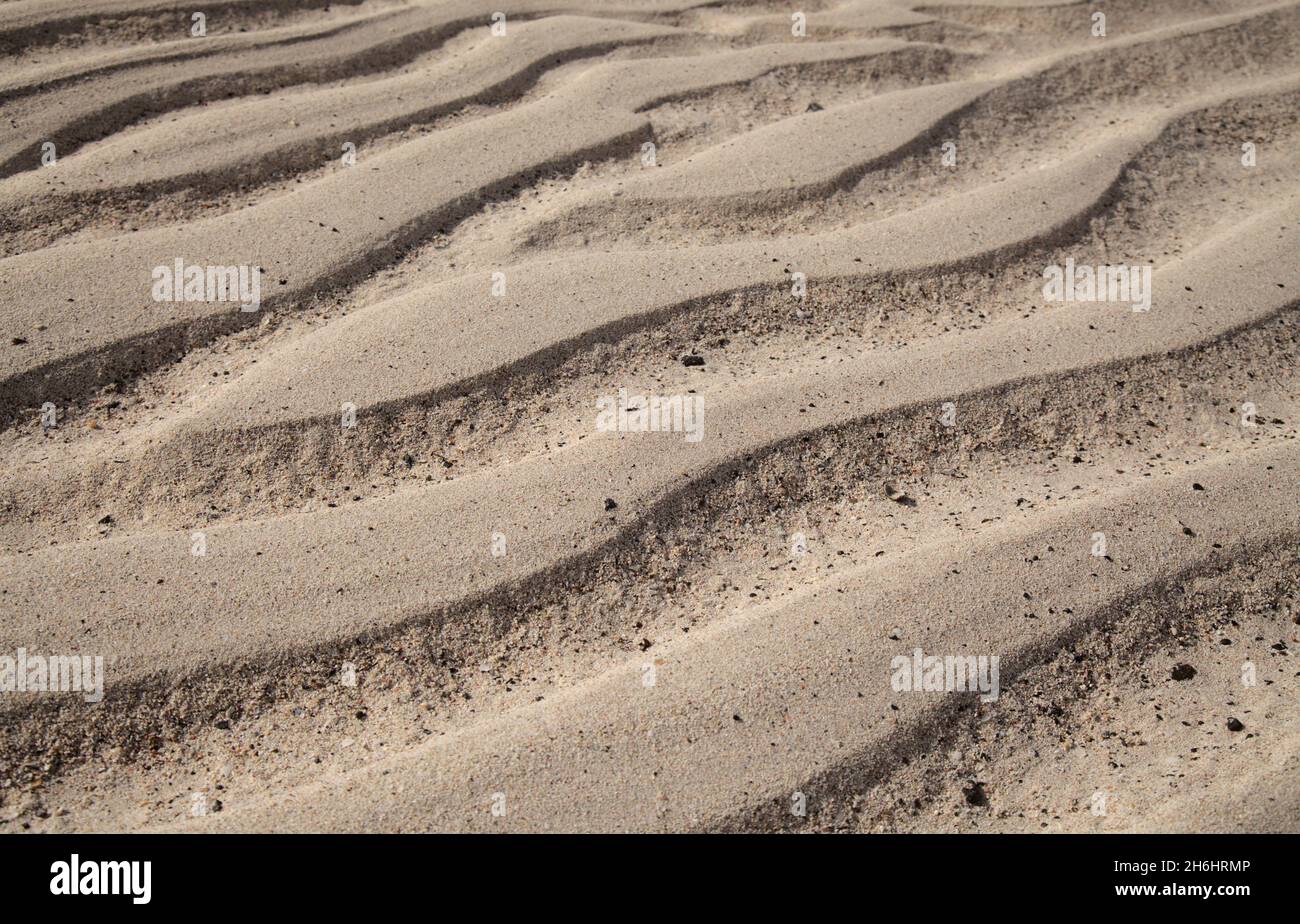 natural sand pattern created by a flow of tide and ripples on the edge ...