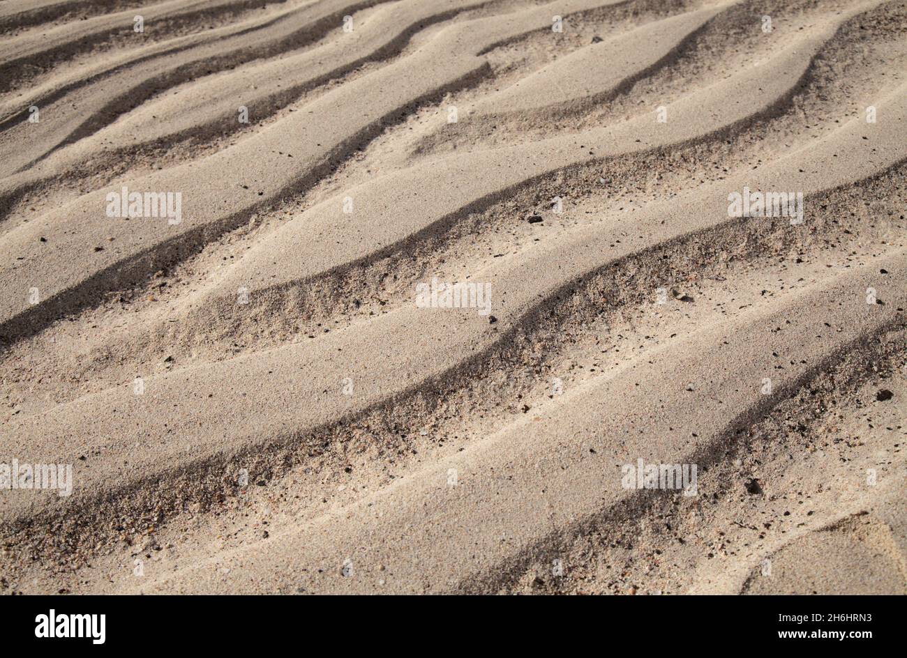 natural sand pattern created by a flow of tide and ripples on the edge ...