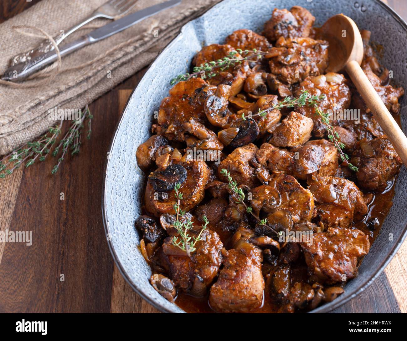 Braised pork tenderloin in a delicious brown mushroom sauce served in a ...
