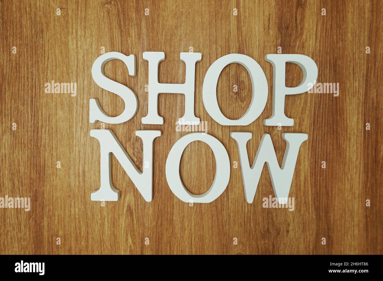 Shop Now word alphabet letters on wooden background Stock Photo - Alamy