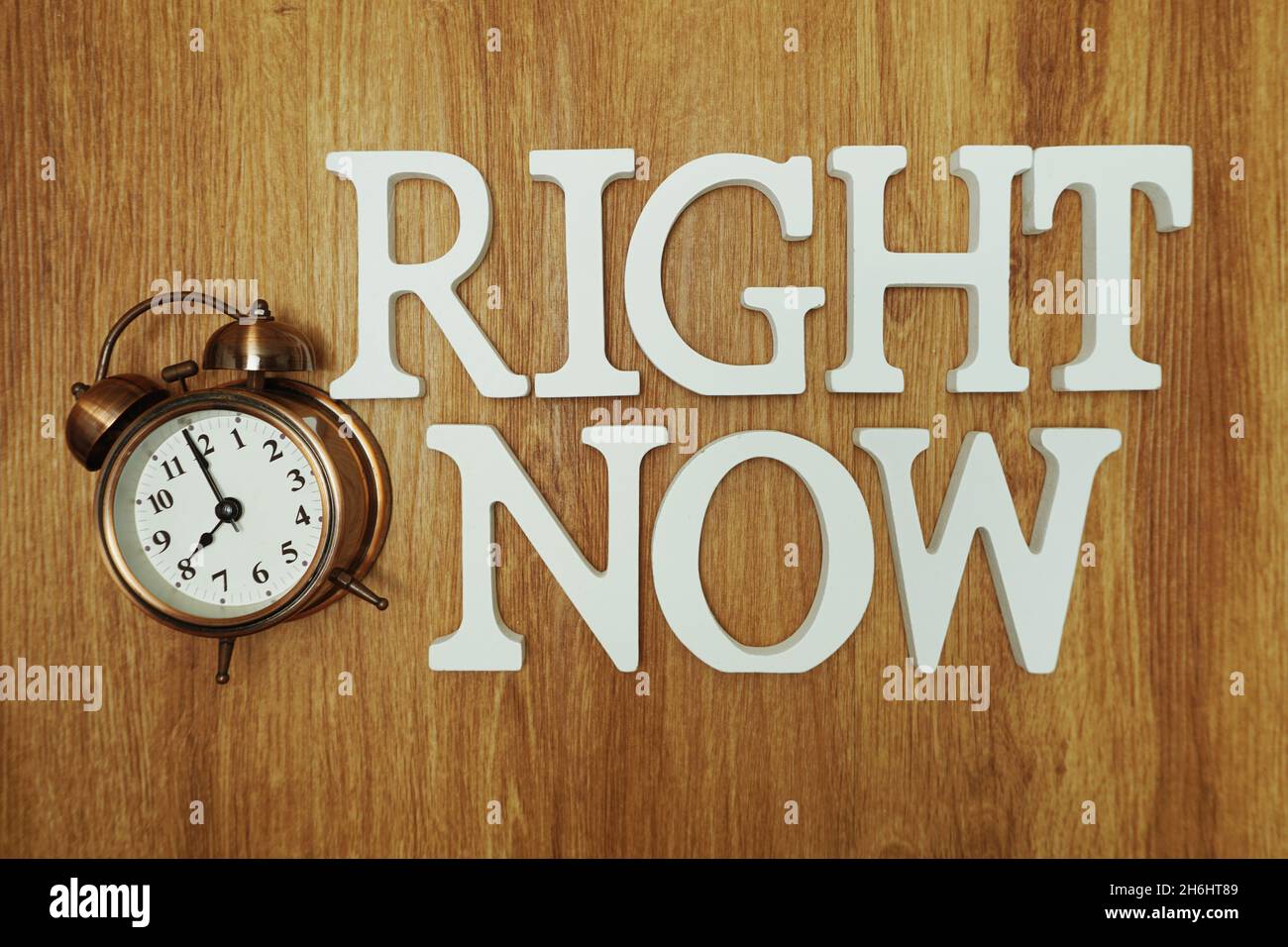 Right Now Word alphabet letters and alarm clock on wooden background ...