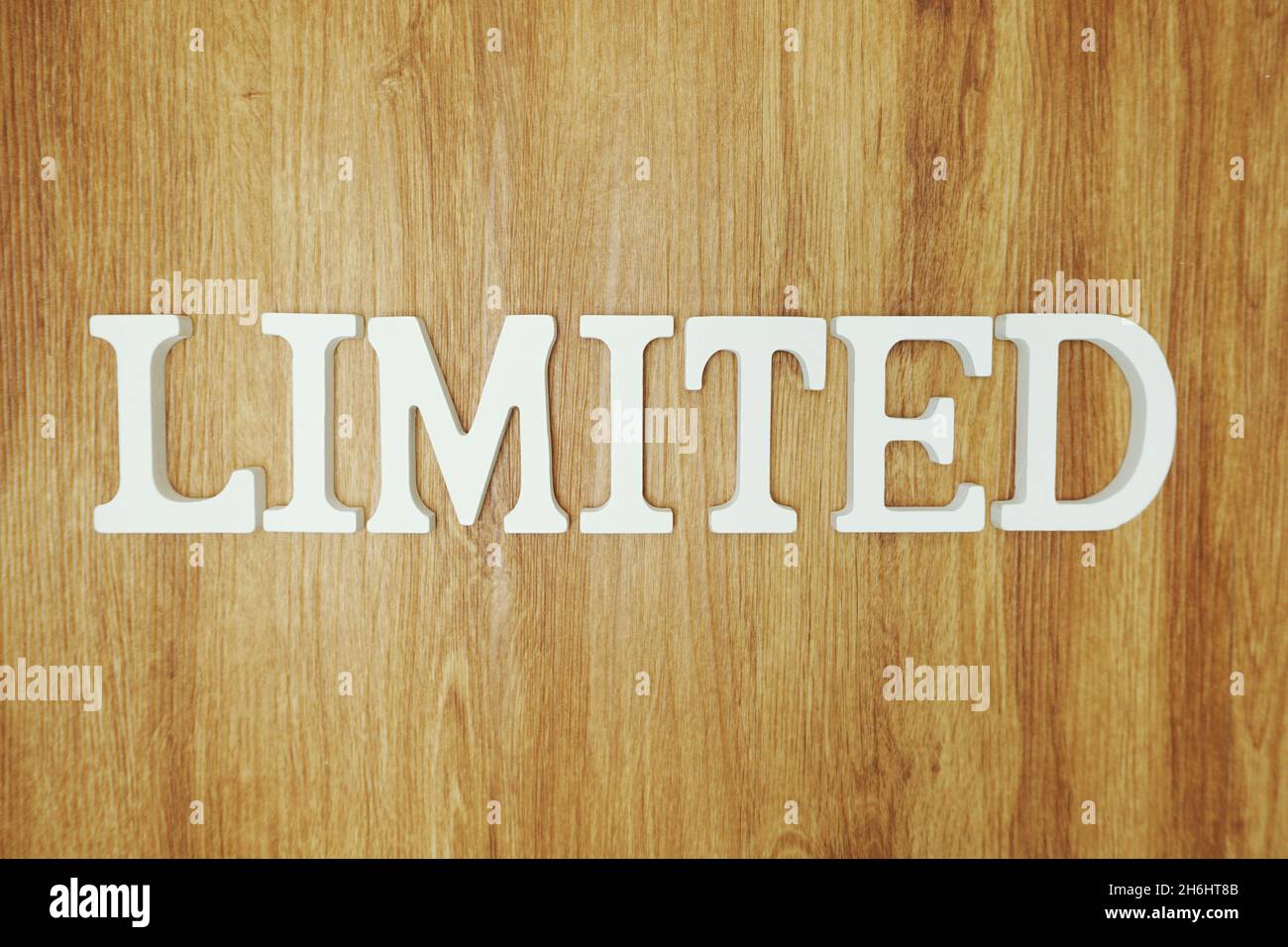 Limited Word alphabet letters on wooden background Stock Photo - Alamy