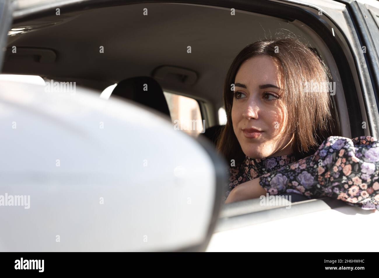 Confident and happy young brunette lady driving in a car Stock Photo ...