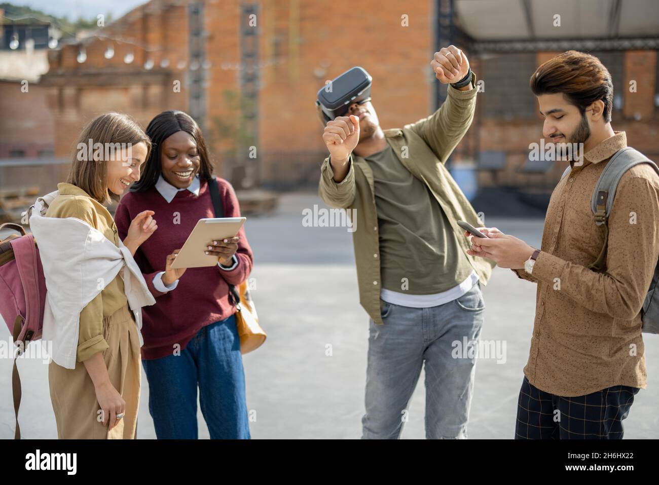 Mixed races students at university campus outdoors Stock Photo - Alamy