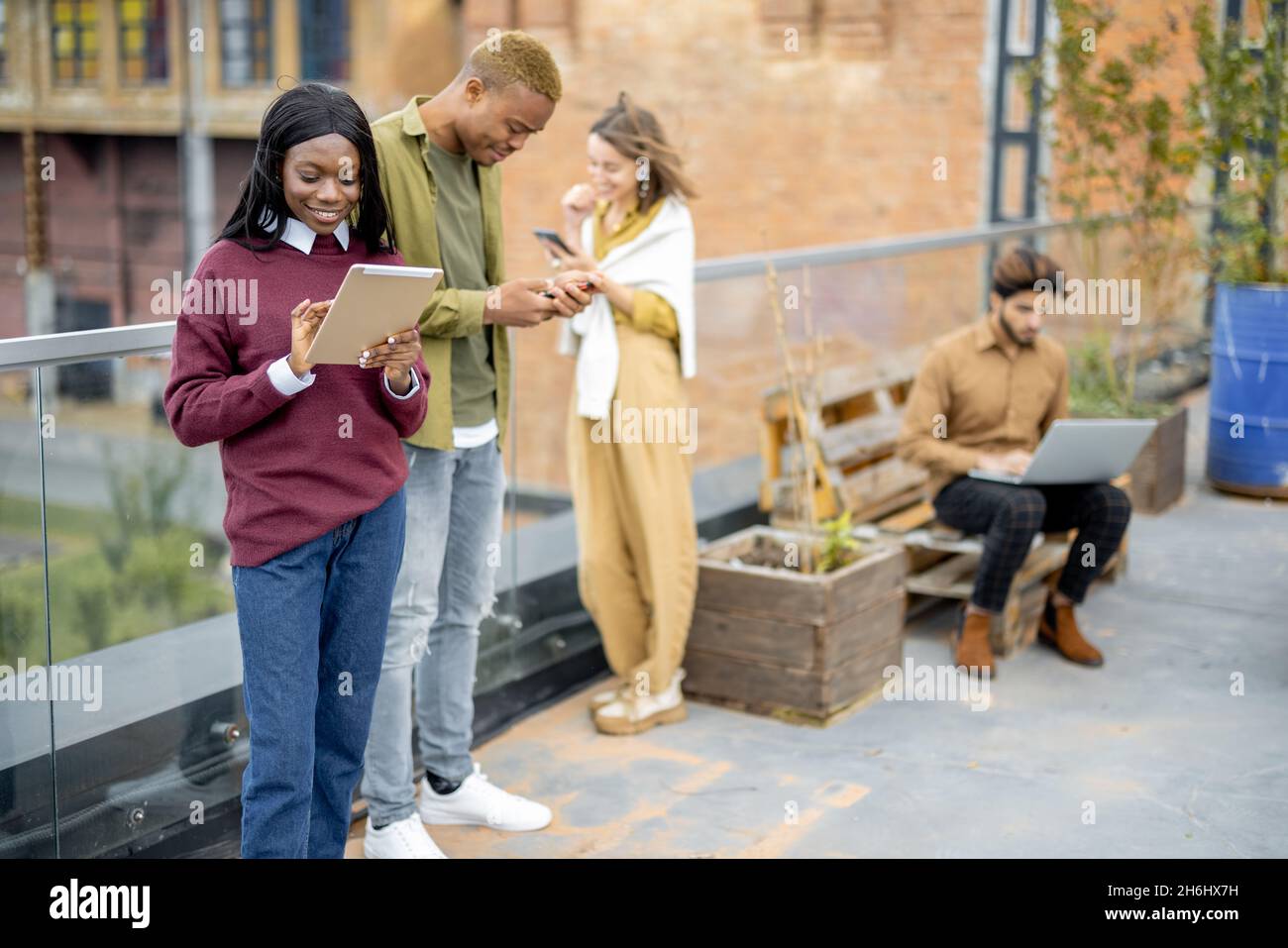 Students use digital devices at university campus Stock Photo - Alamy