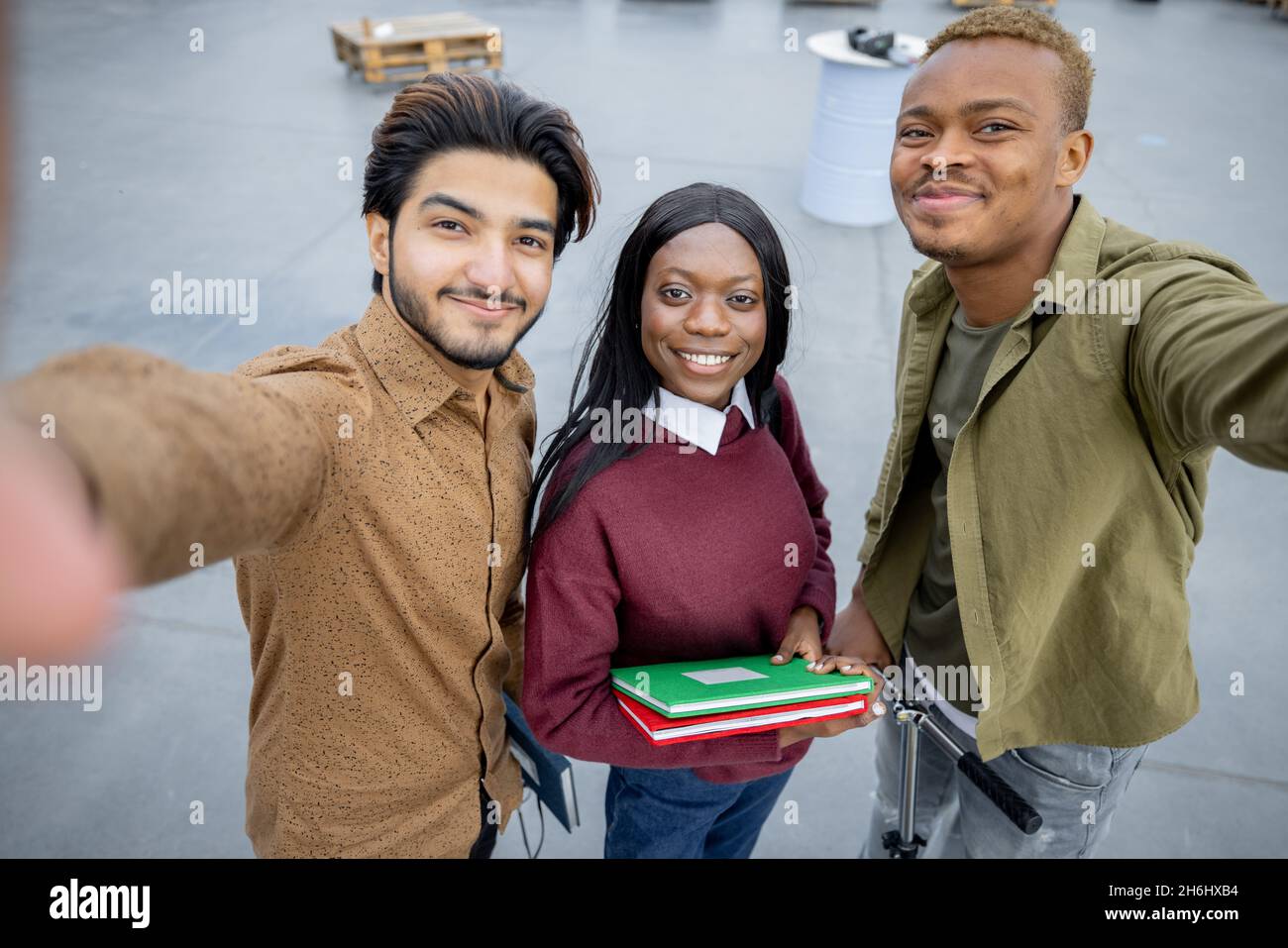 Students looking at camera at university campus Stock Photo - Alamy