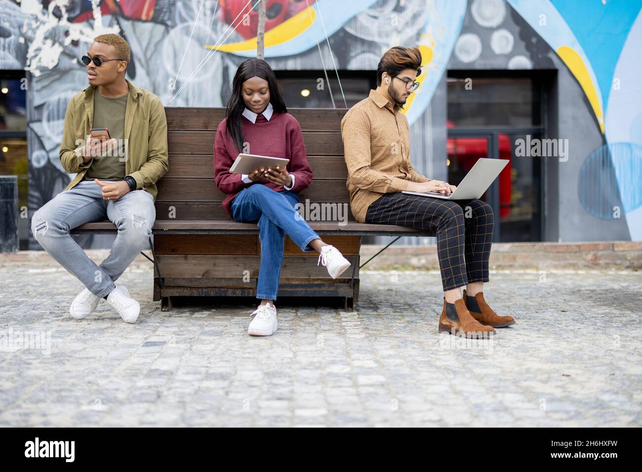 Young students using gadgets at university campus Stock Photo - Alamy