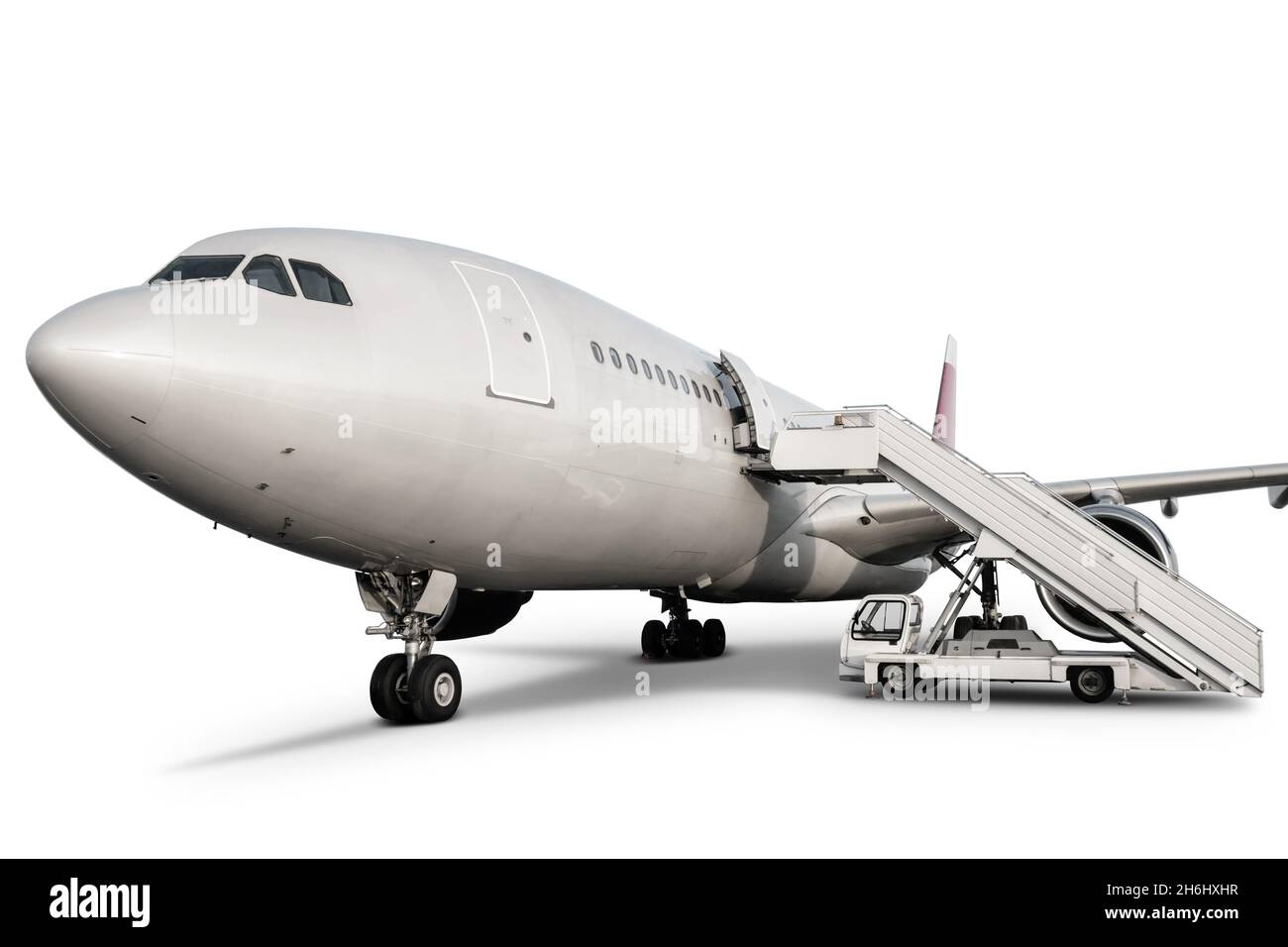 Wide body passenger airplane with boarding ramp isolated on white ...