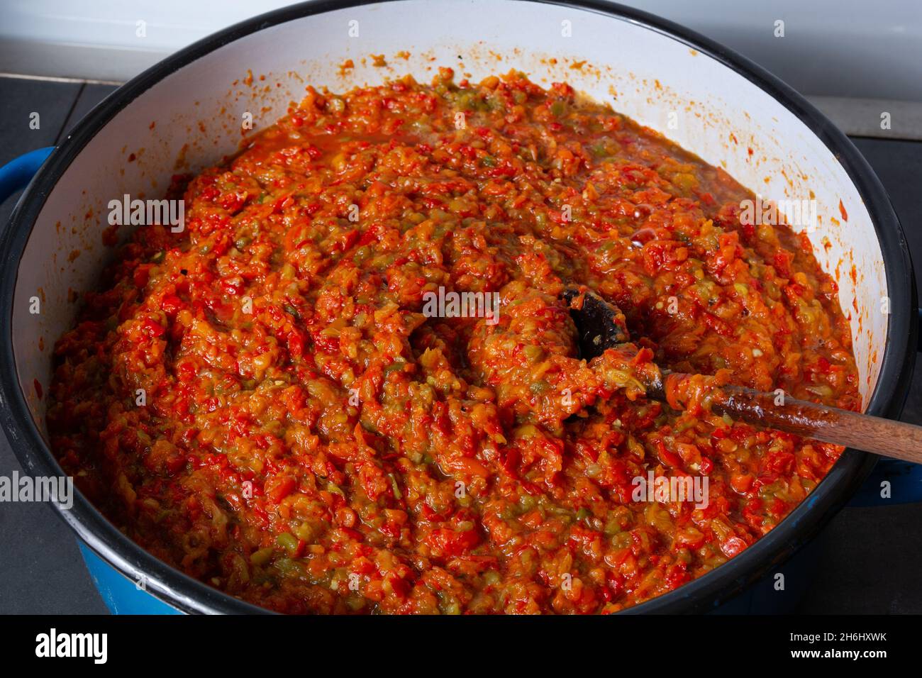 Ajvar traditional Balkan food in a big pot on the stove. Process of ...
