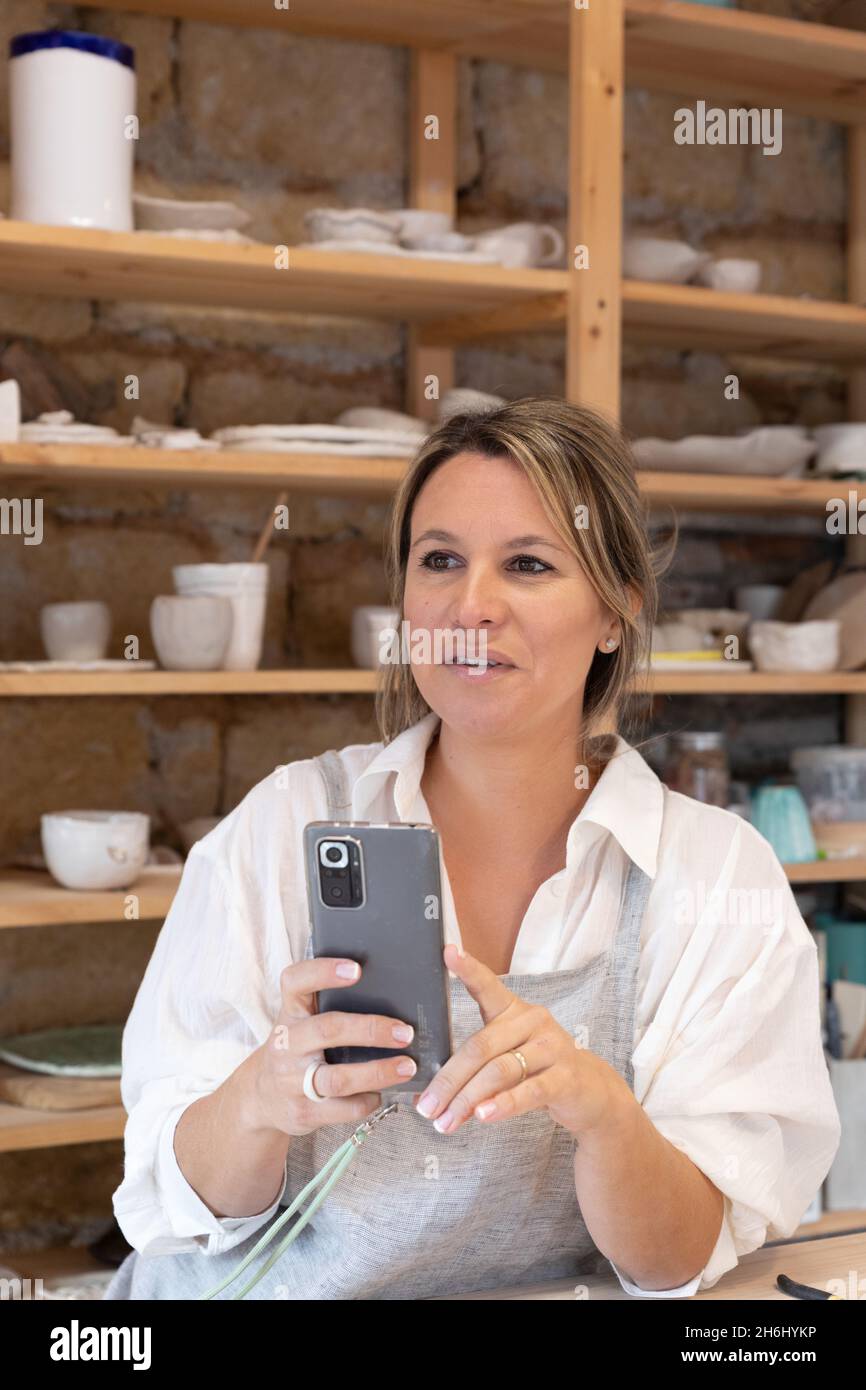 An Attractive professional craftswoman in her beautiful workshop Stock ...