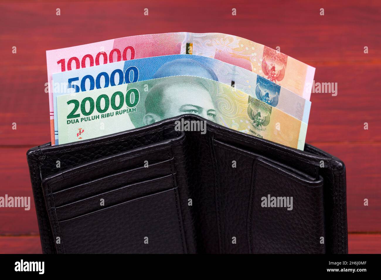 Indonesian money - rupiah in the black wallet Stock Photo - Alamy