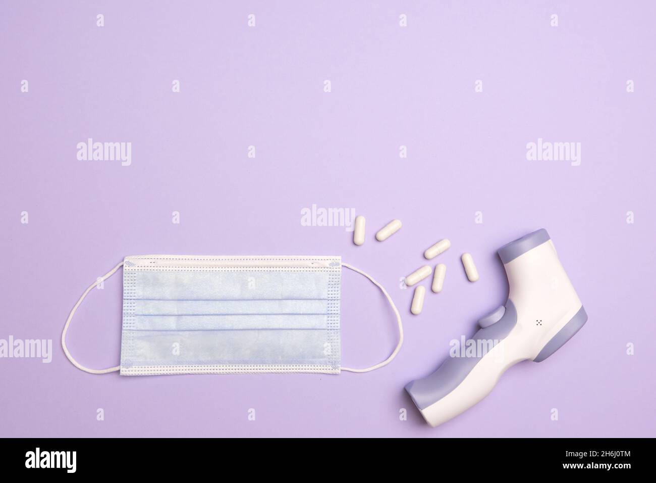 Non-contact infrared thermometer gun isolated on pastel colorful ...