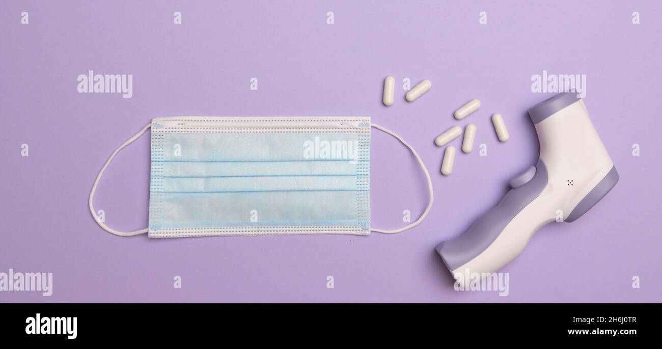 Non-contact infrared thermometer gun isolated on pastel colorful ...