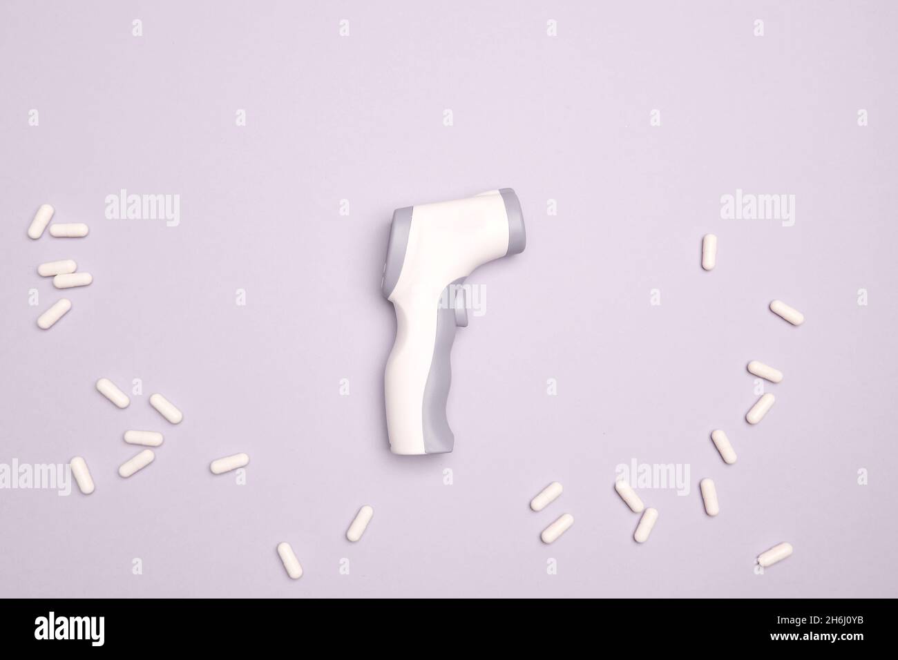 Non-contact infrared thermometer gun isolated on pastel colorful ...