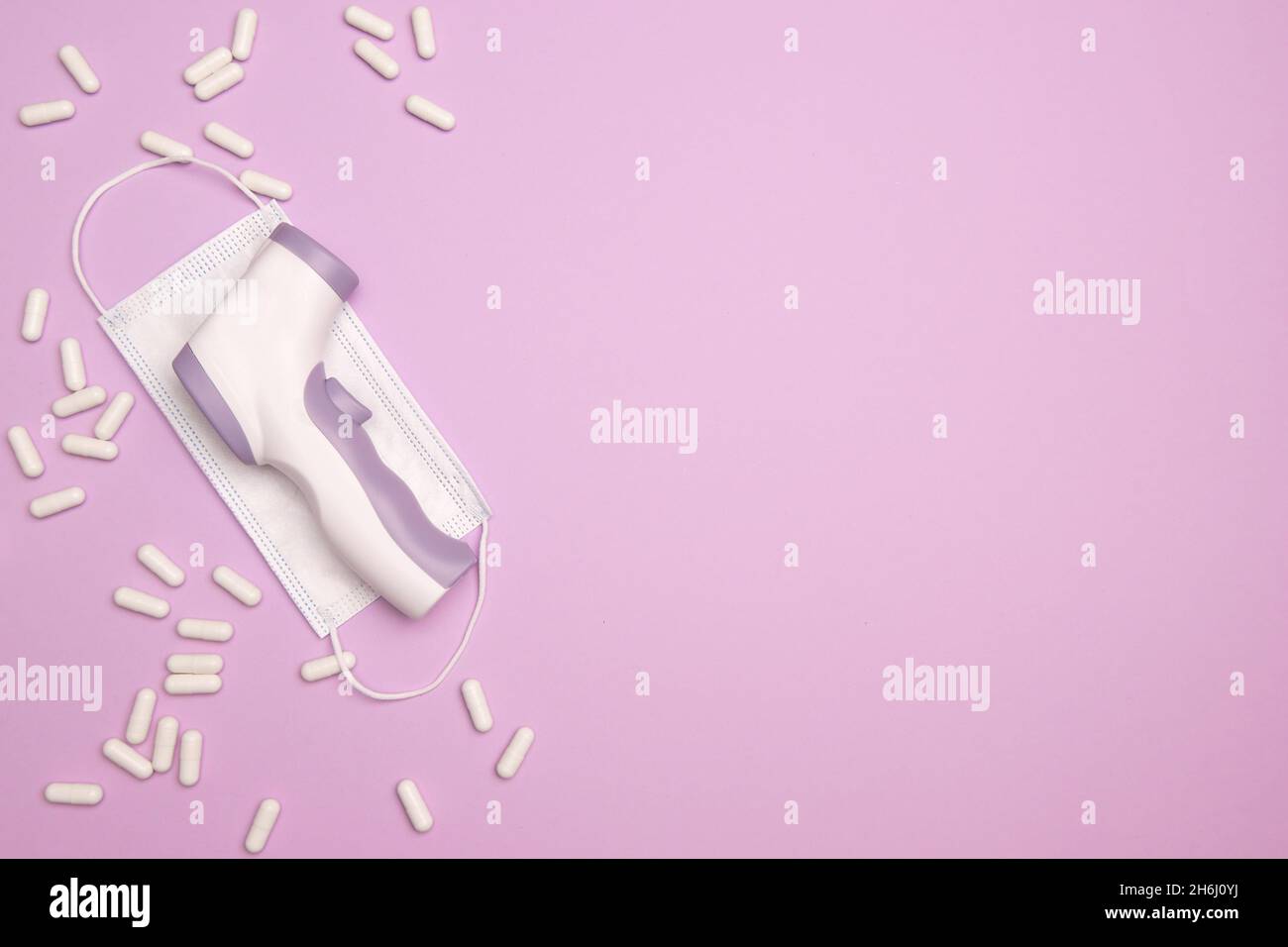 Non-contact infrared thermometer gun isolated on pastel colorful ...