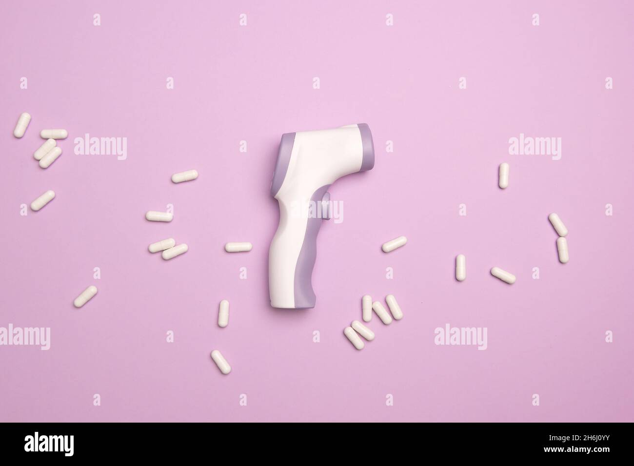 Non-contact infrared thermometer gun isolated on pastel colorful ...