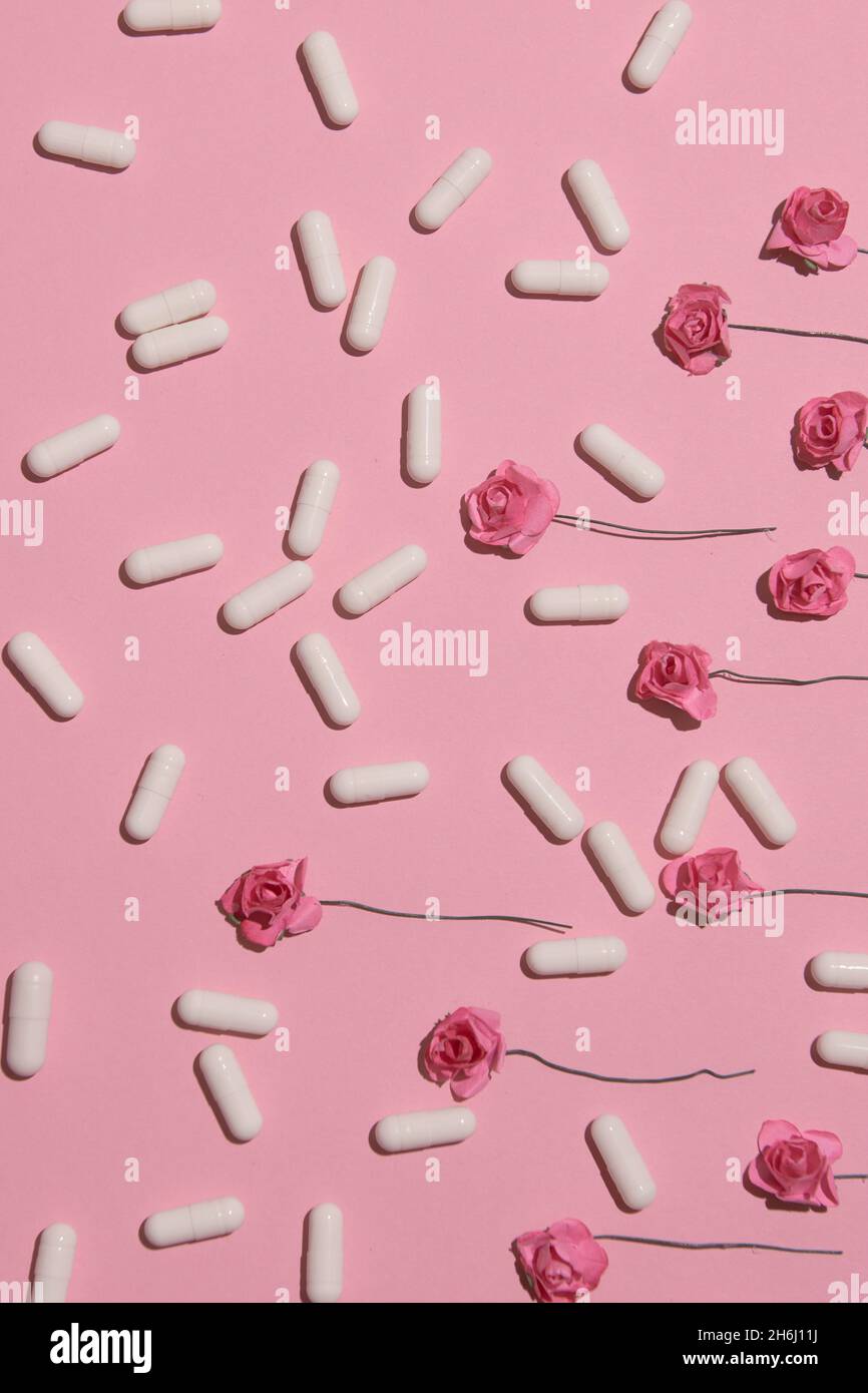 Many white capsule pills on a colorful background. Supplements and ...