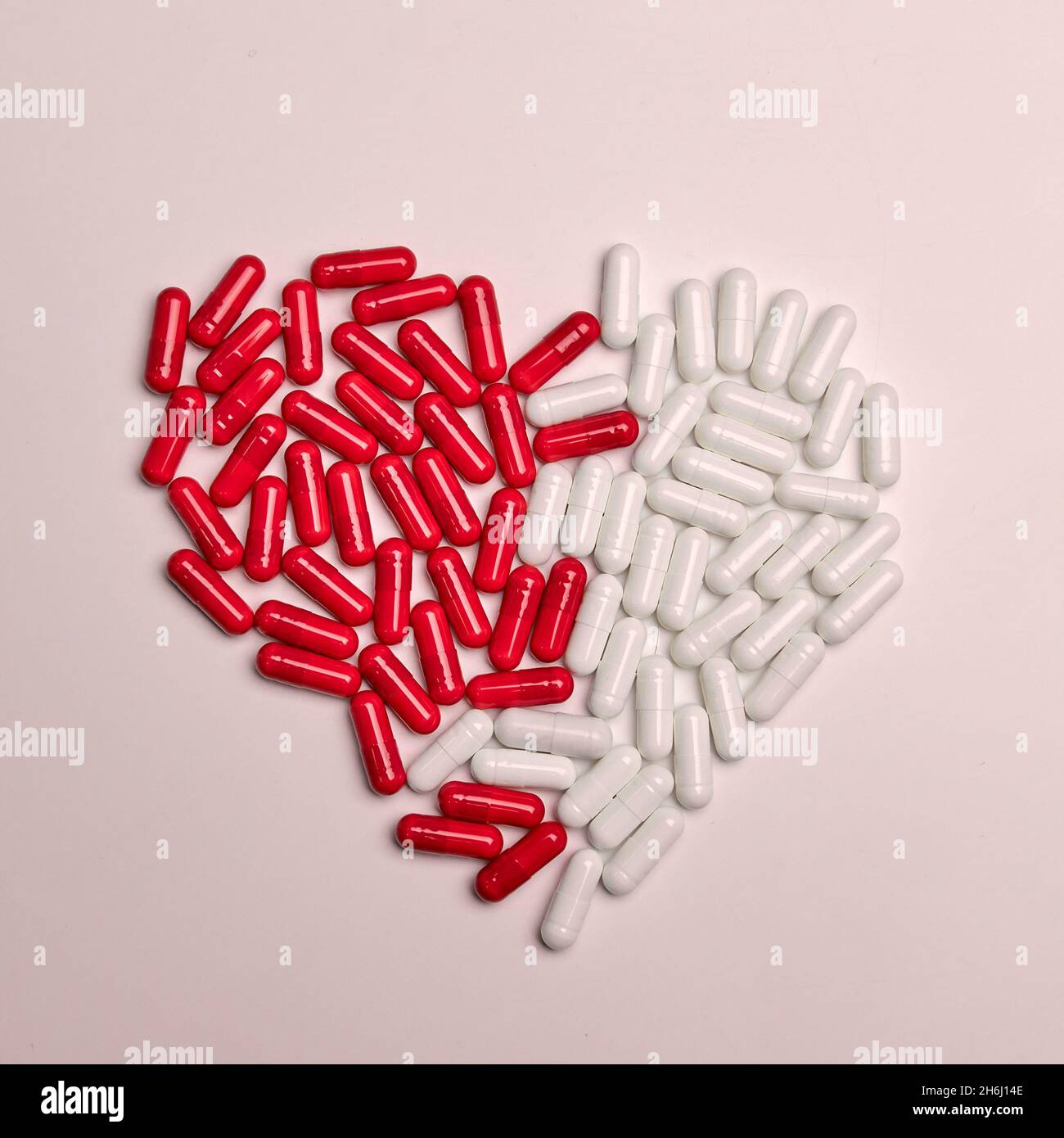 Many white capsule pills vitamin B3 on a colorful background ...