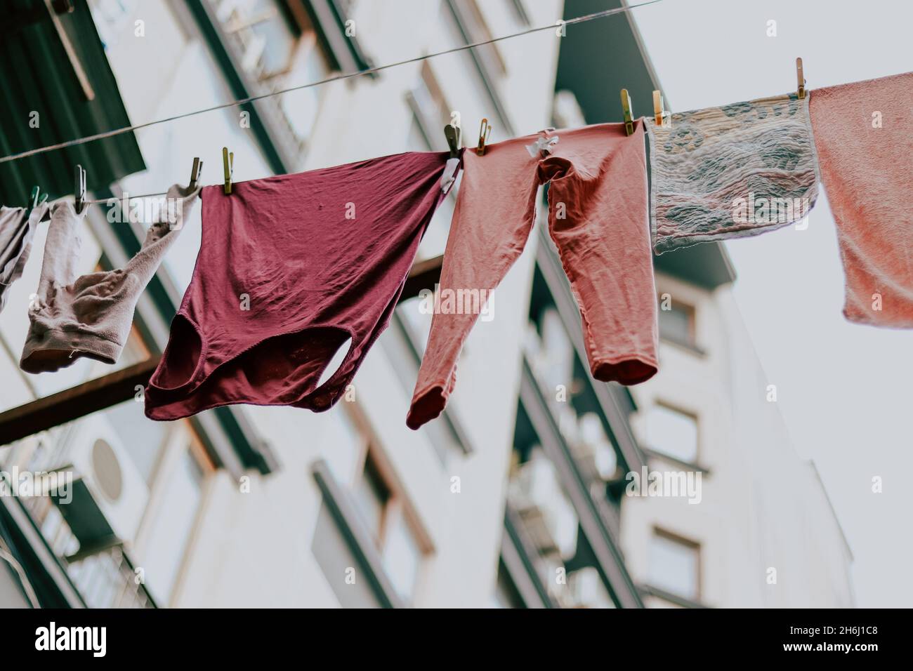 Drying children's clothes outside. Washed laundry on a rope Stock Photo ...