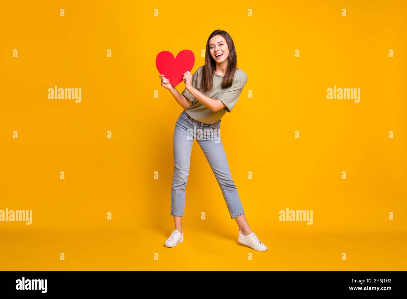 Full body photo of cheerful happy woman hold red paper heart wear white ...