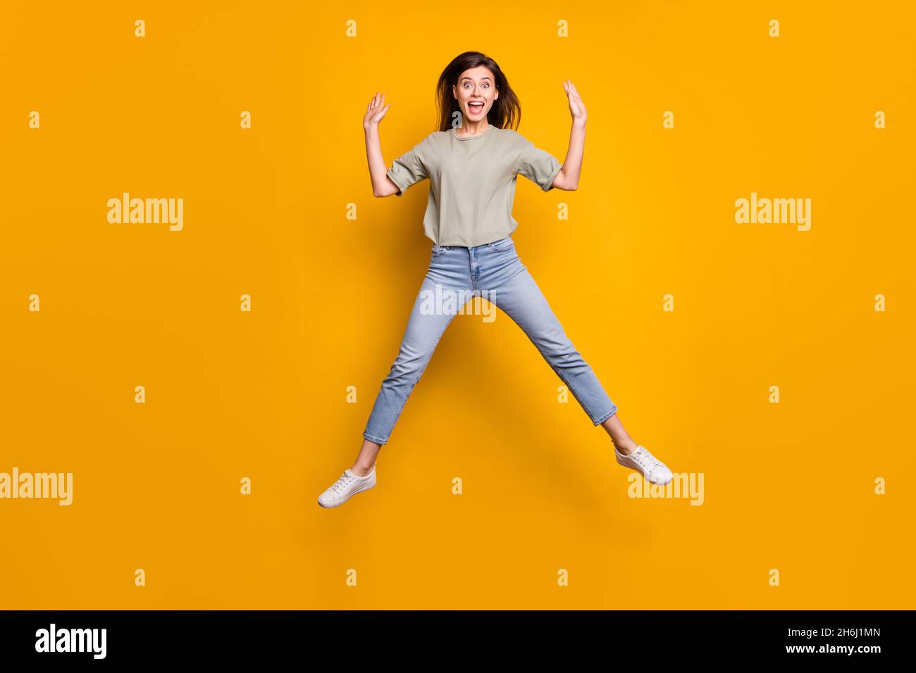 Full size photo of happy cute shocked girl jump up air raise hands ...