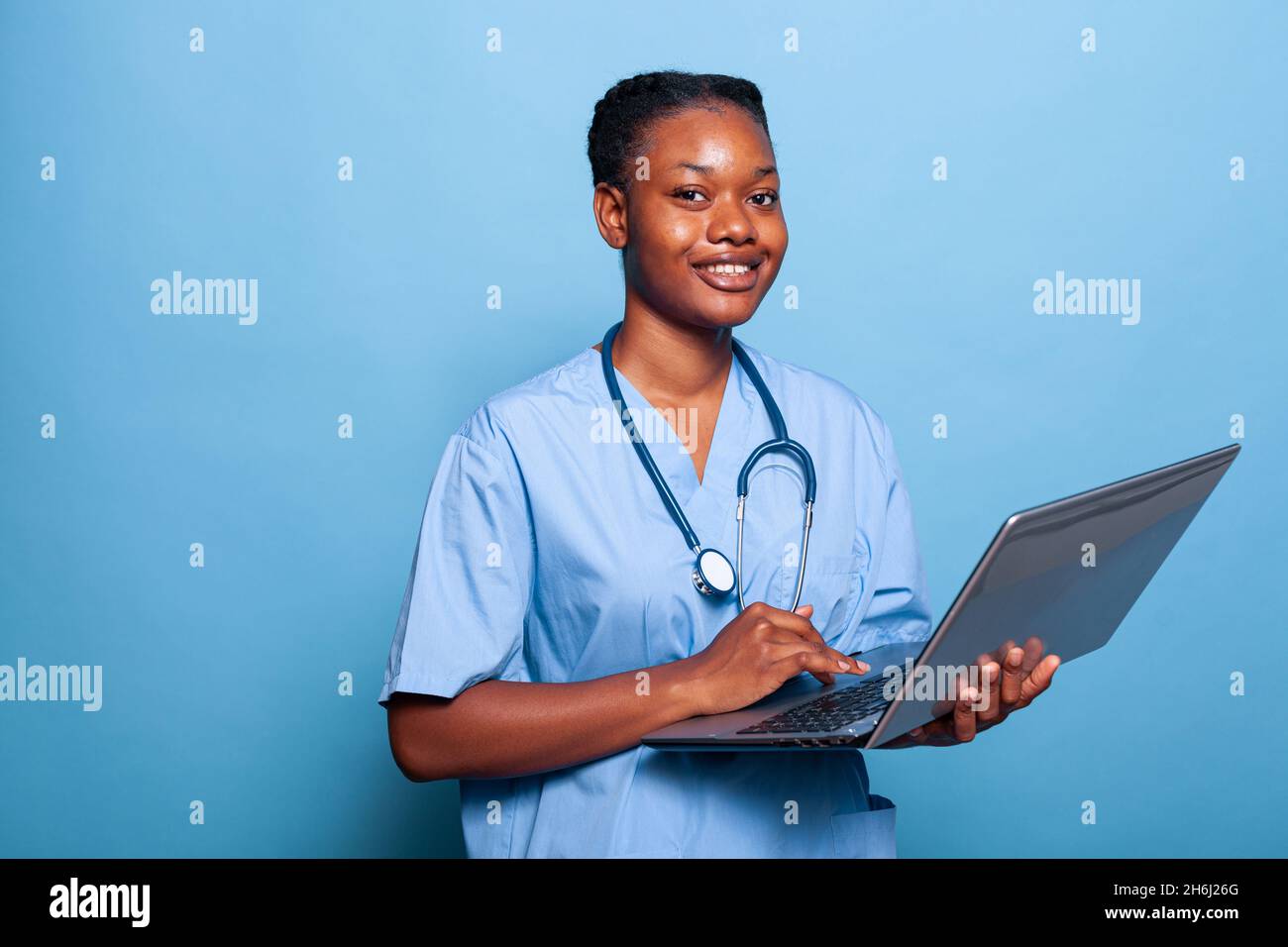 Portrait of african american practitioner nurse smiling at camera while ...