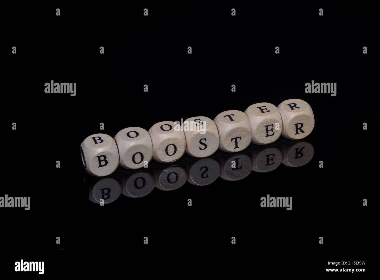 Letter throws against a black background form the word booster, the ...