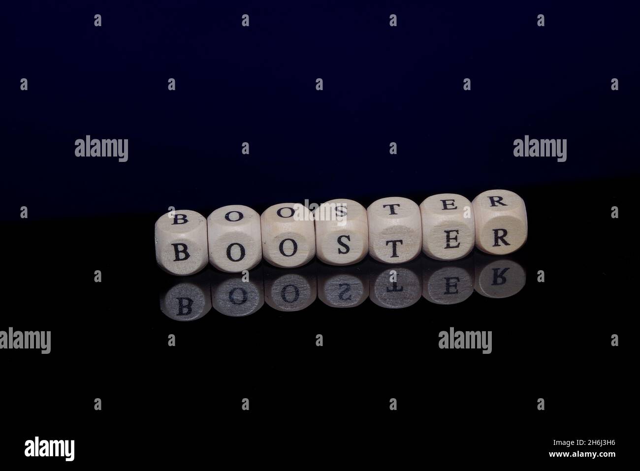 Letter throws against a black background form the word booster, the ...
