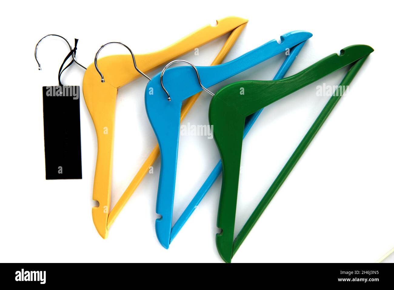 Wooden Coat hangers with black paper label isolated on white background ...