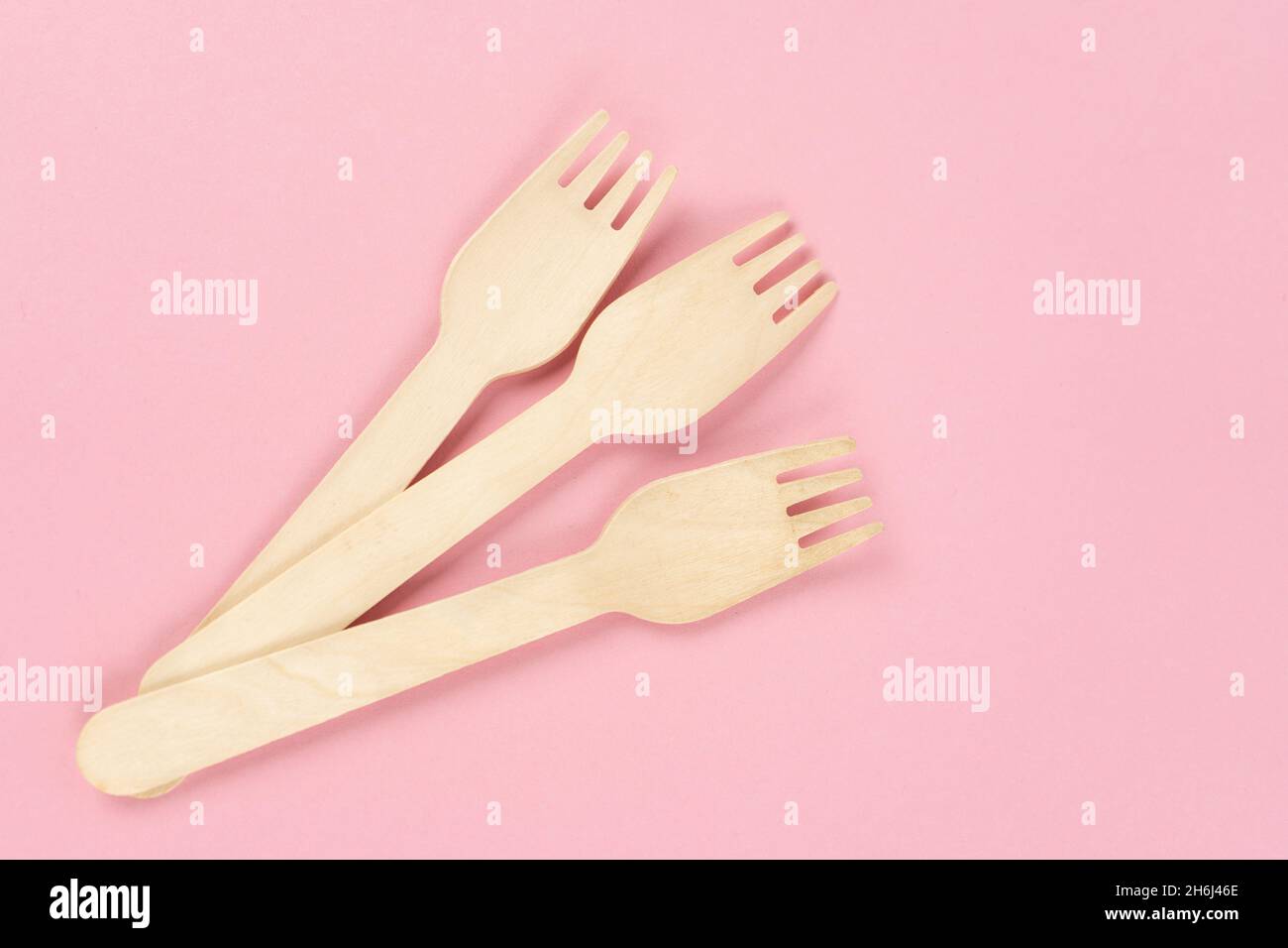 Wooden forks on a pink background. Natural eco-friendly disposable ...