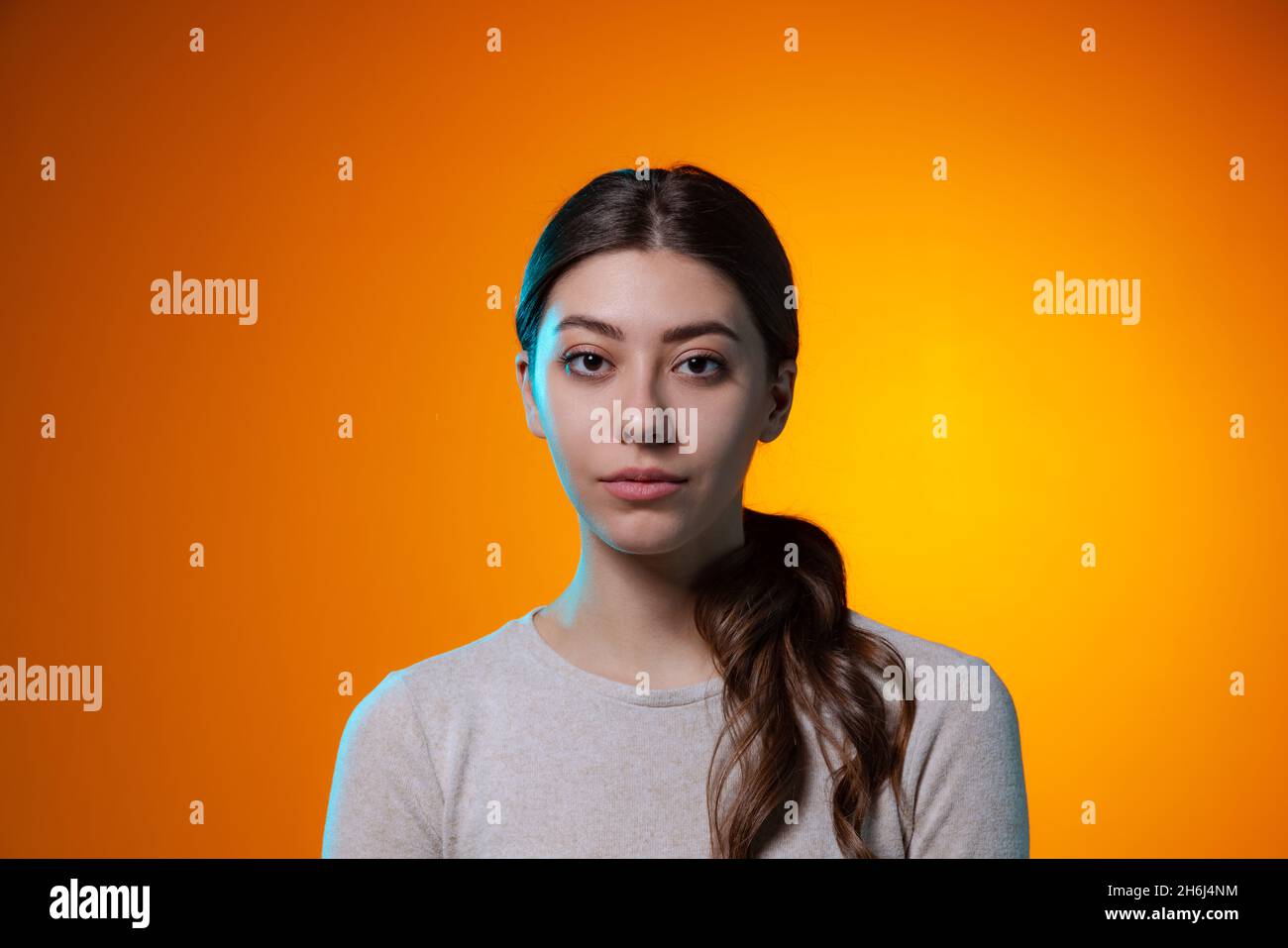 Close-up portrait of young beautiful sad, serious girl looking at ...