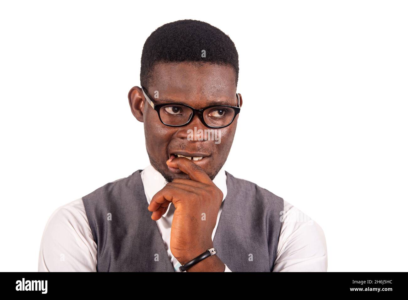 young businessman thinking keeping his hand under his mouth, looking at ...
