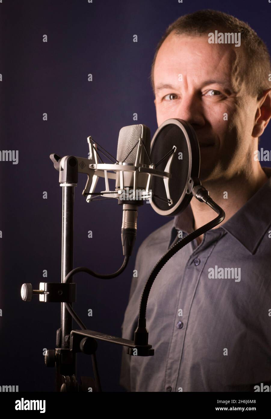 Voiceover artist voice actor in vocal recording studio with larg ...