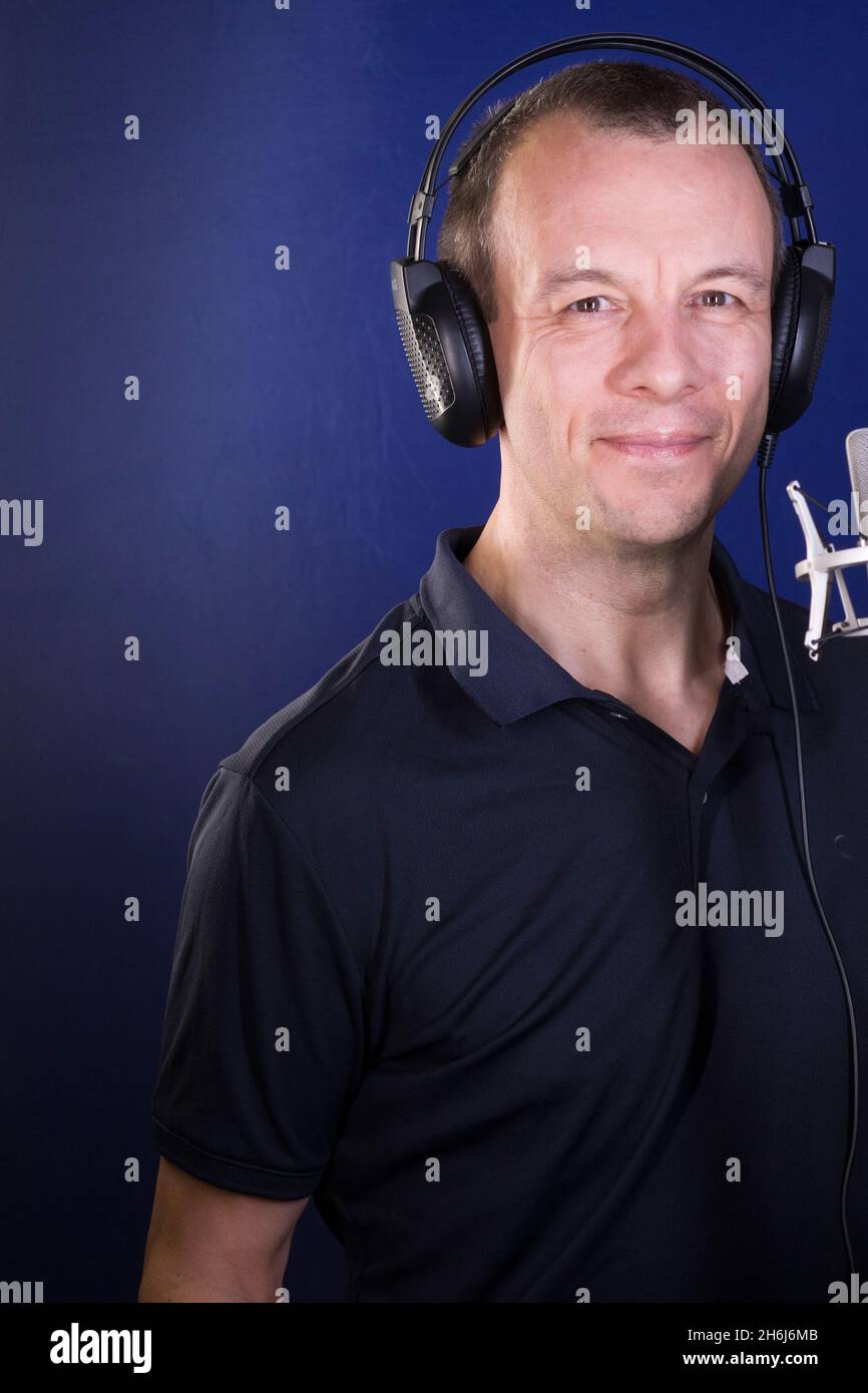 Voiceover artist voice actor in vocal recording studio with larg ...