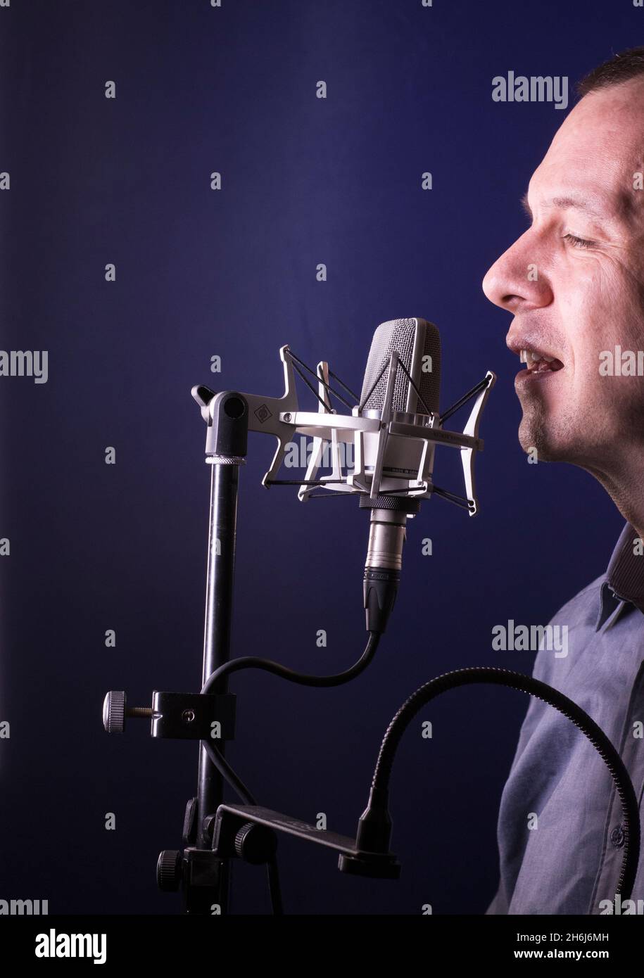 Voiceover artist voice actor in vocal recording studio with larg ...