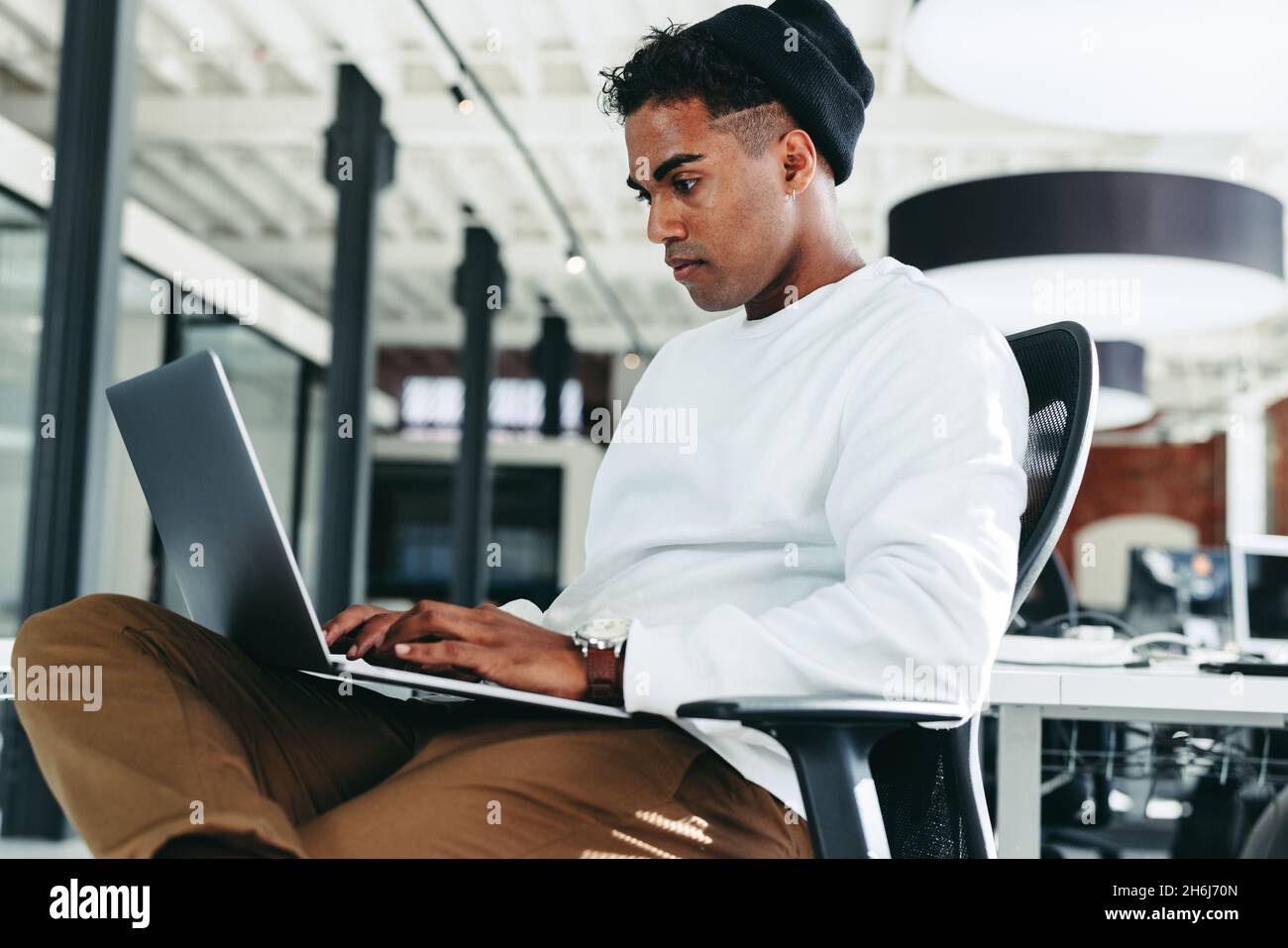 Software developer working on a new project in an office. Focused young ...