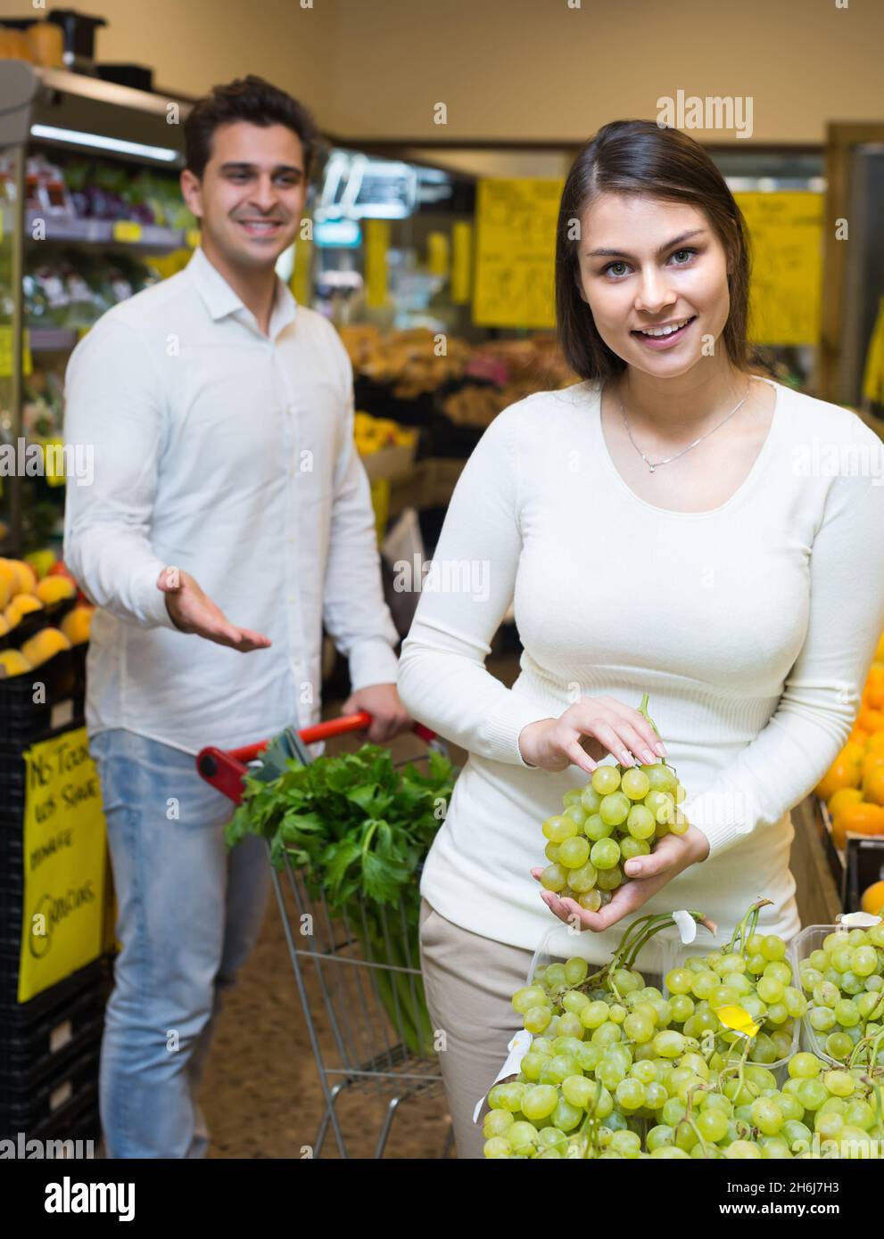 Young spouses choosing fruits Stock Photo - Alamy