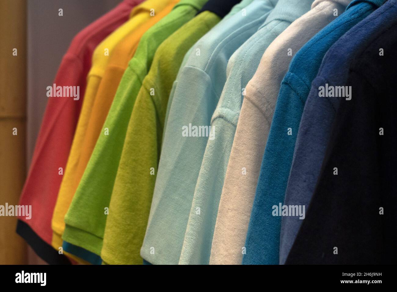 many different colors t shirts on stand Stock Photo - Alamy