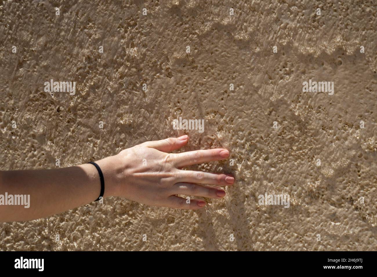 Hand through water wall hi-res stock photography and images - Alamy