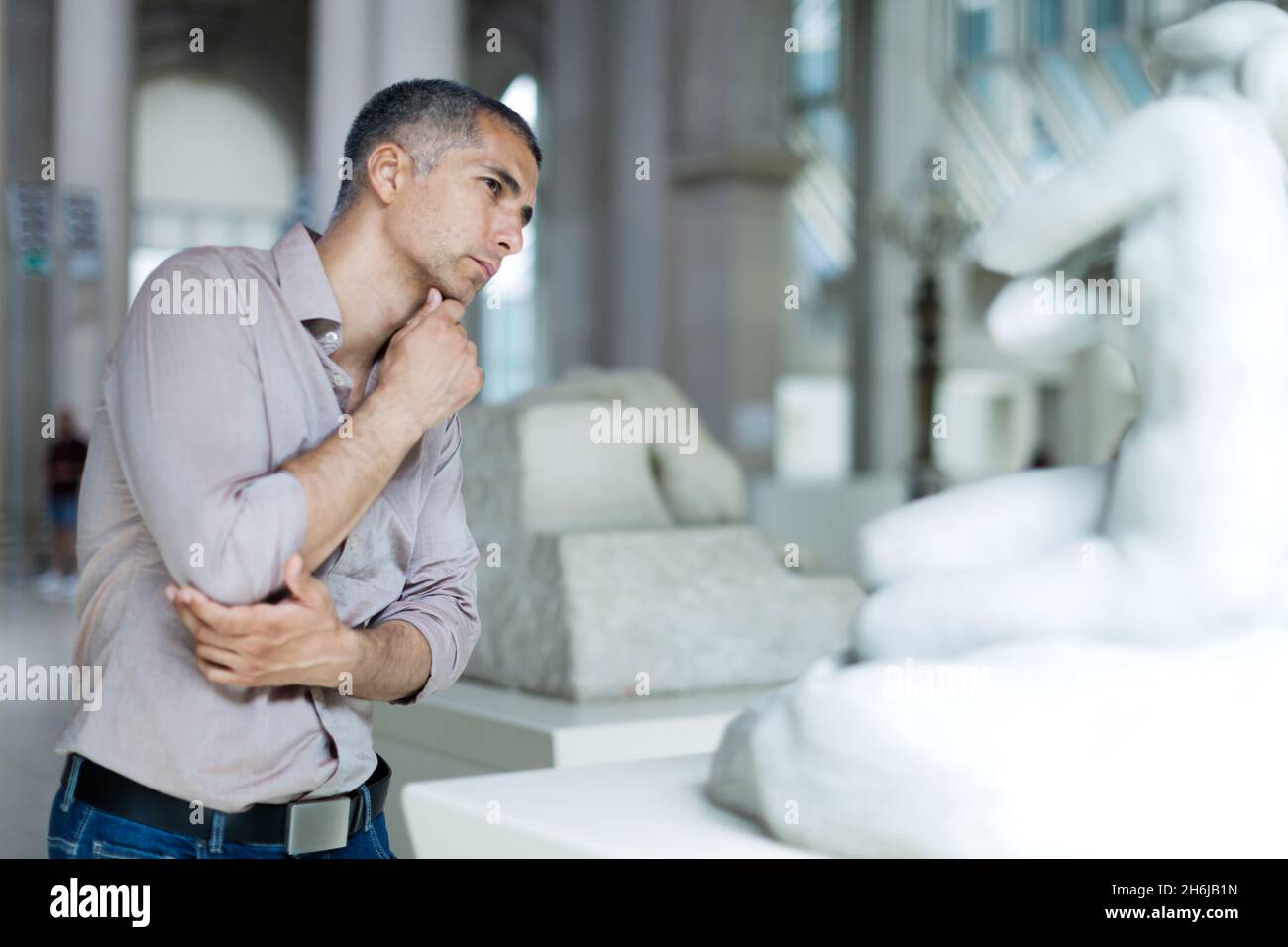 Adult man is visiting museum and looking at the exposition Stock Photo ...